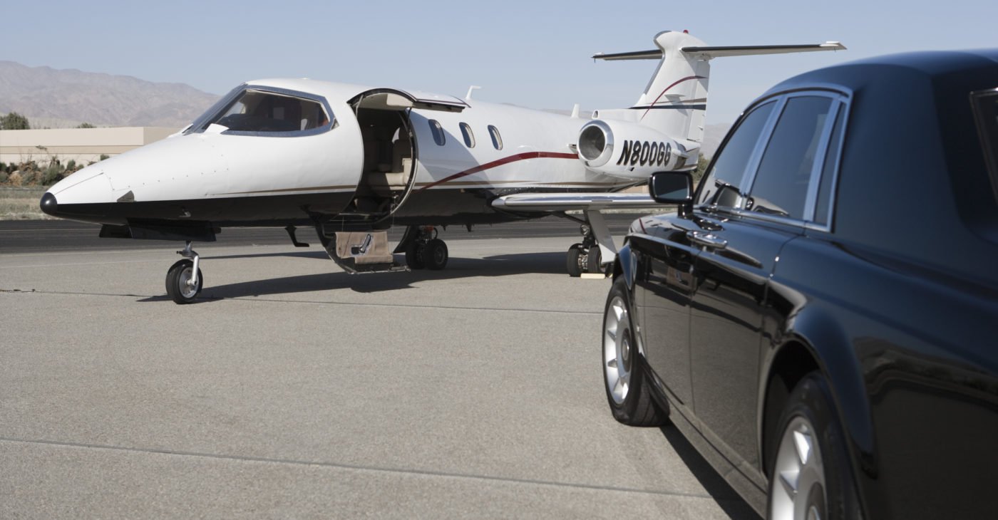Corporate jet with a black town car on the tarmac. Roseville’s limo rental.